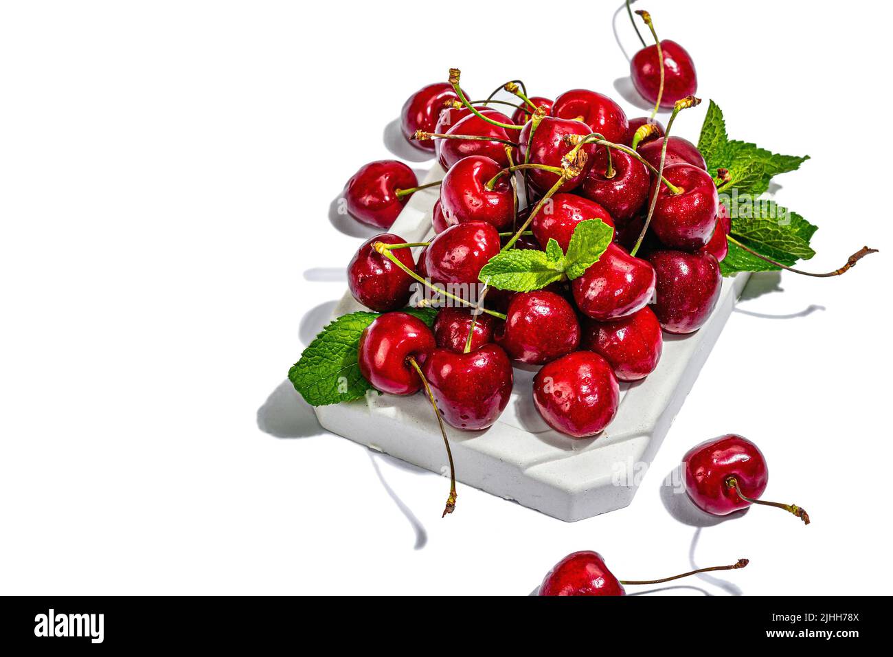 Ripe sweet cherries with fresh mint leaves isolated on white background ...