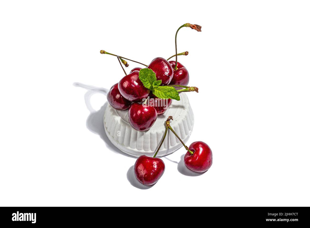 Ripe sweet cherries with fresh mint leaves isolated on white background ...