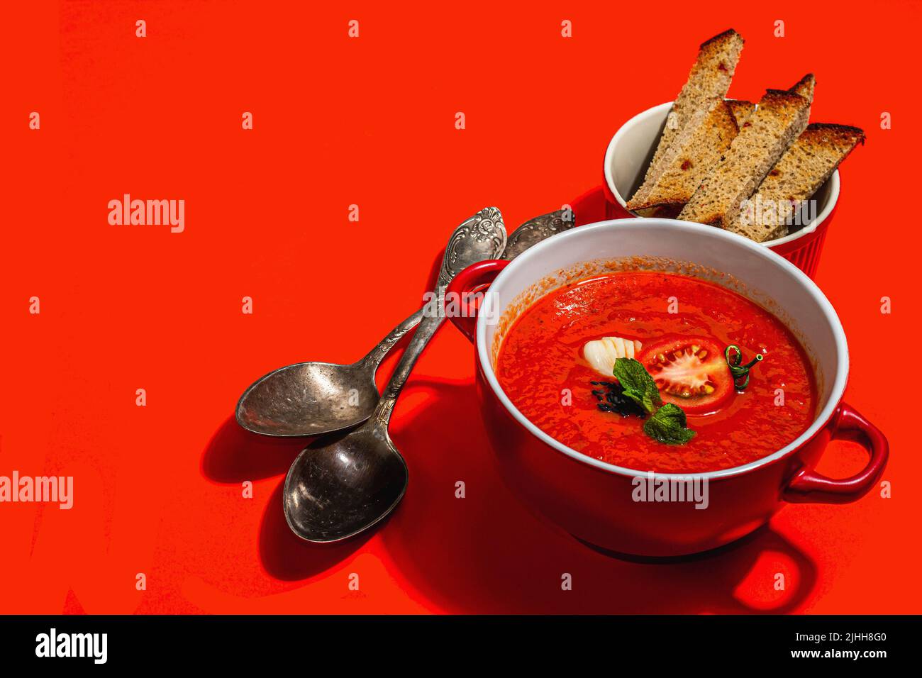 Spicy tomato soup. Healthy vegan hot dish, croutons, vintage cutlery ...