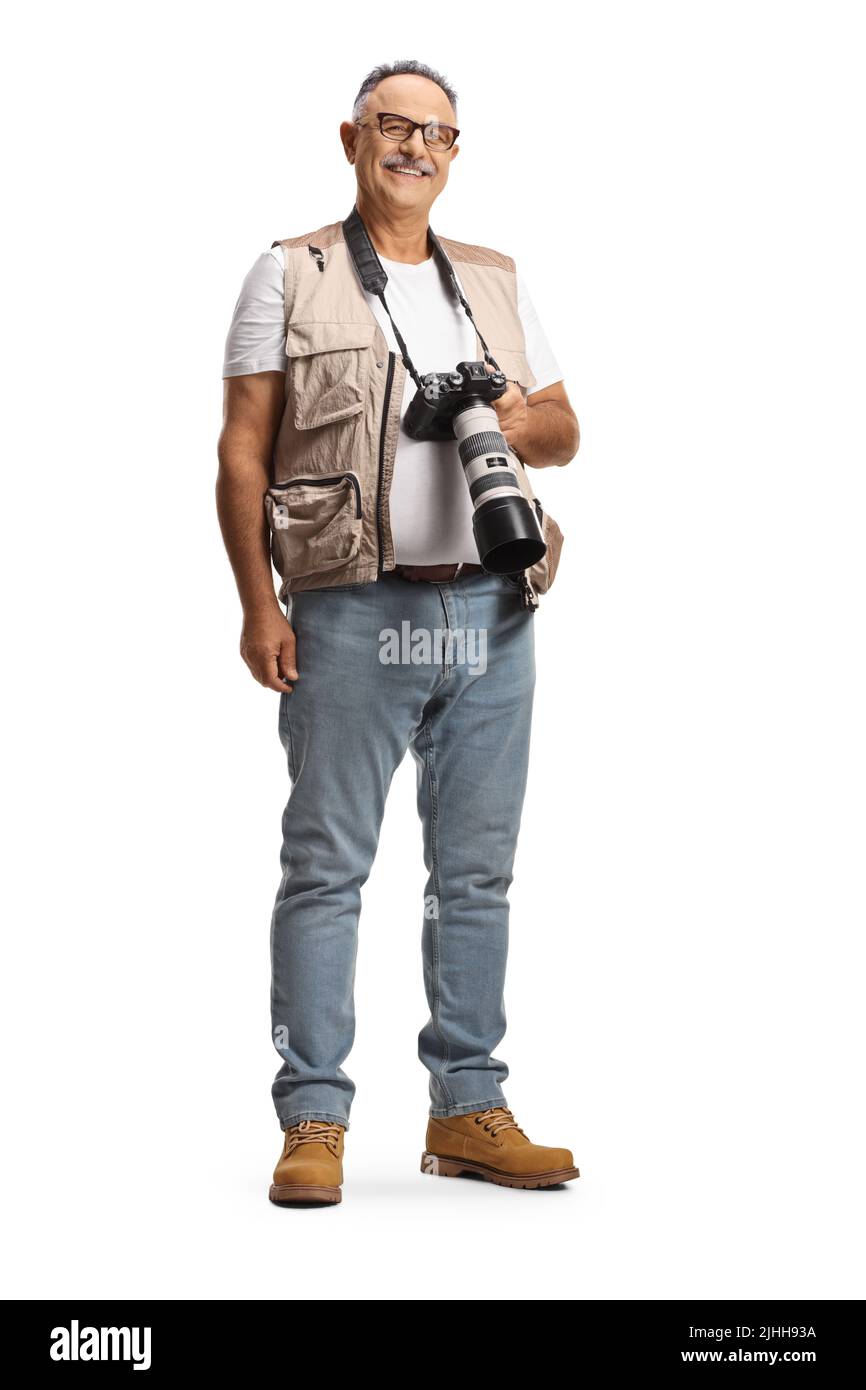Full length portrait of a mature male photo journalist holding a ...