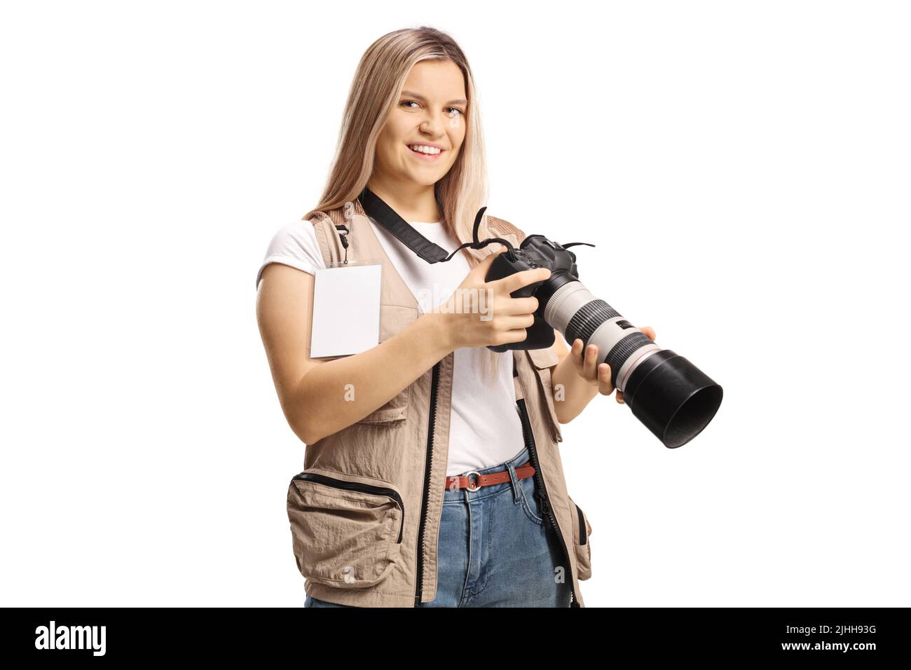 Young female photo journalist holding a professional camera and smiling ...