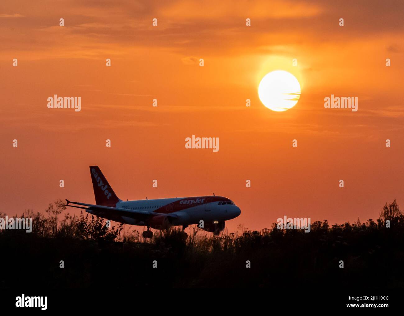 Easy Jet plane lands during sunset at Luton Airport after a small ...