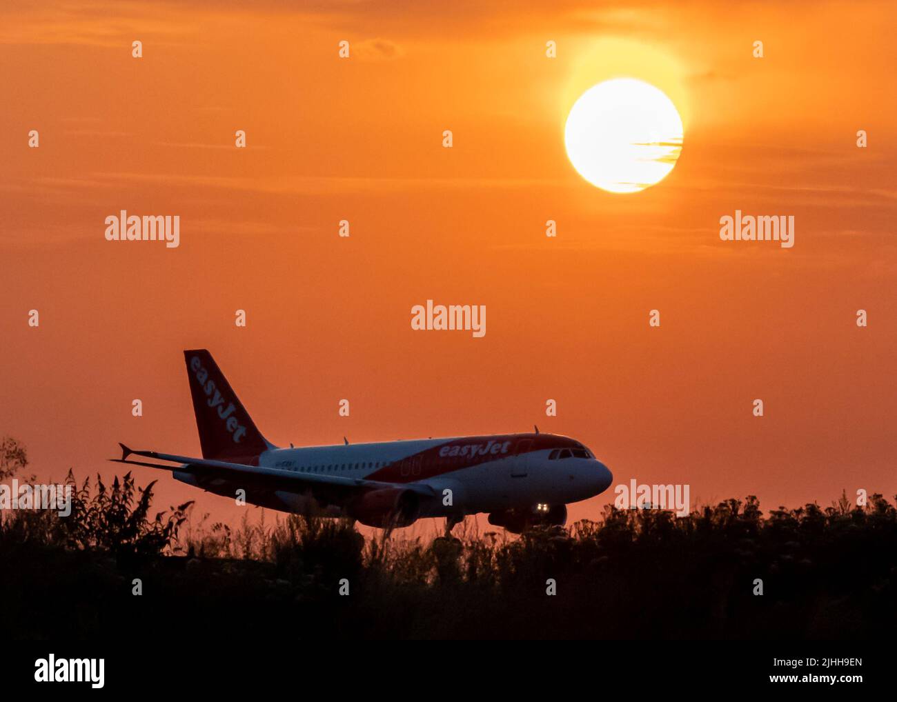 Easy Jet plane lands during sunset at Luton Airport after a small ...