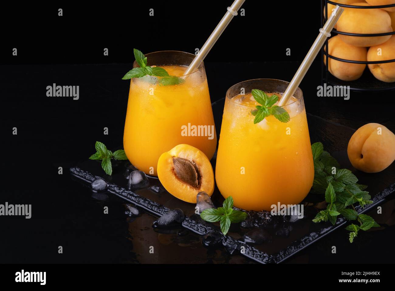 Fresh sweet apricot juice and mint on a black background Stock Photo ...