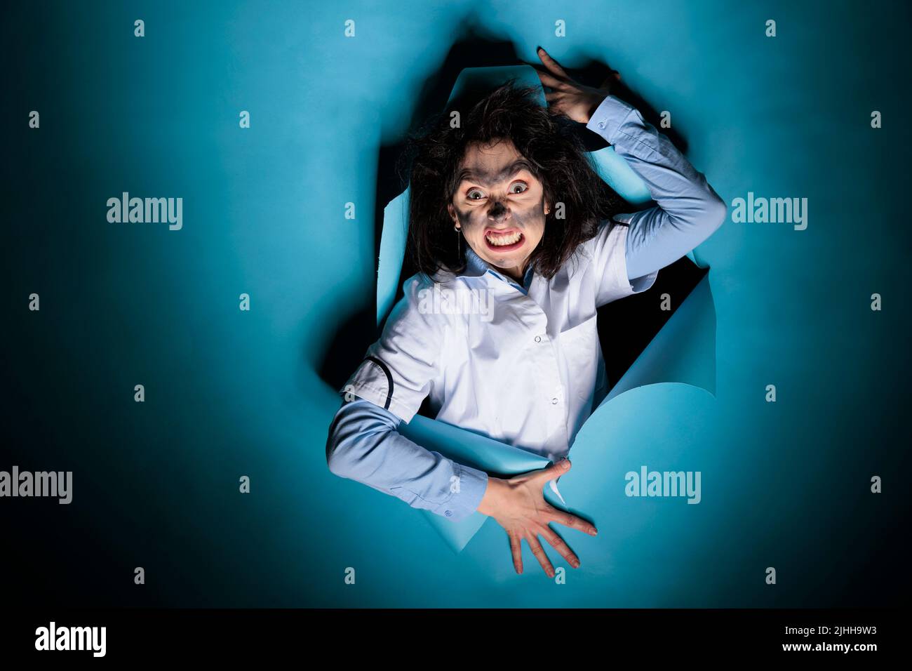 Crazy silly biochemist with dirty face and messy hairstyle grinning ...