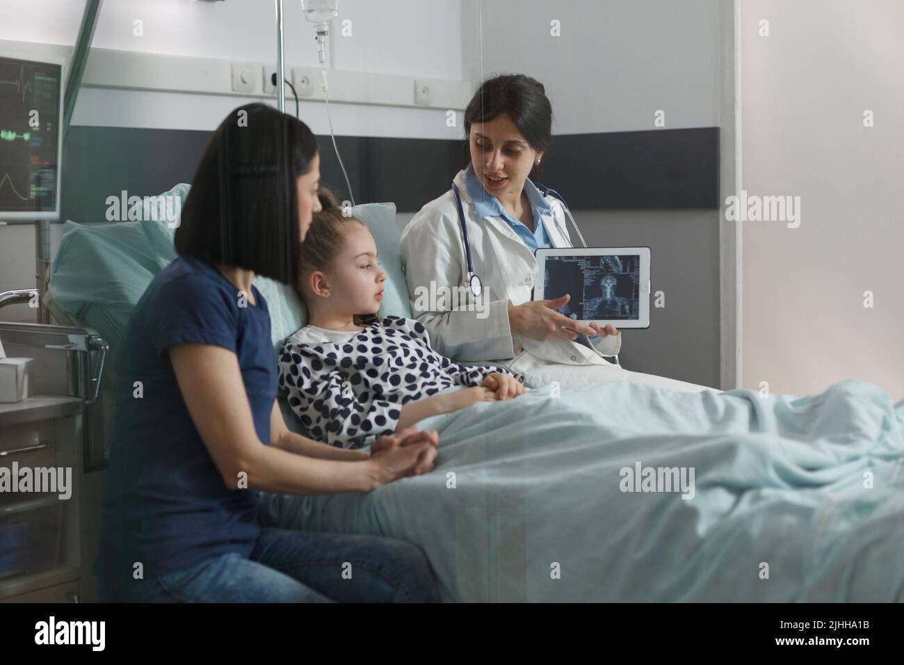 Radiology expert examining radiography scan image of sick little girl ...