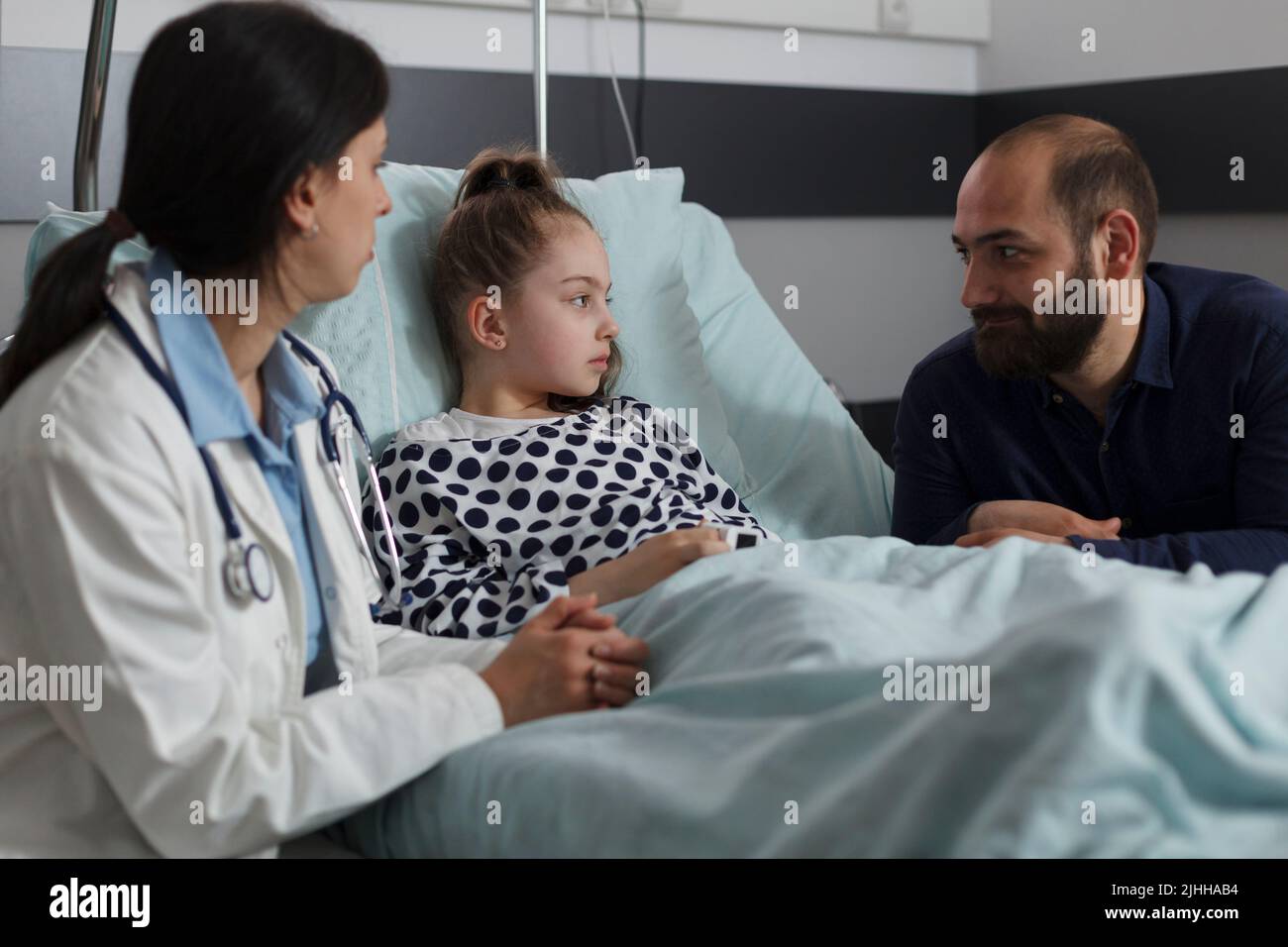 Pediatrician examining ill kid health condition while discussing with ...