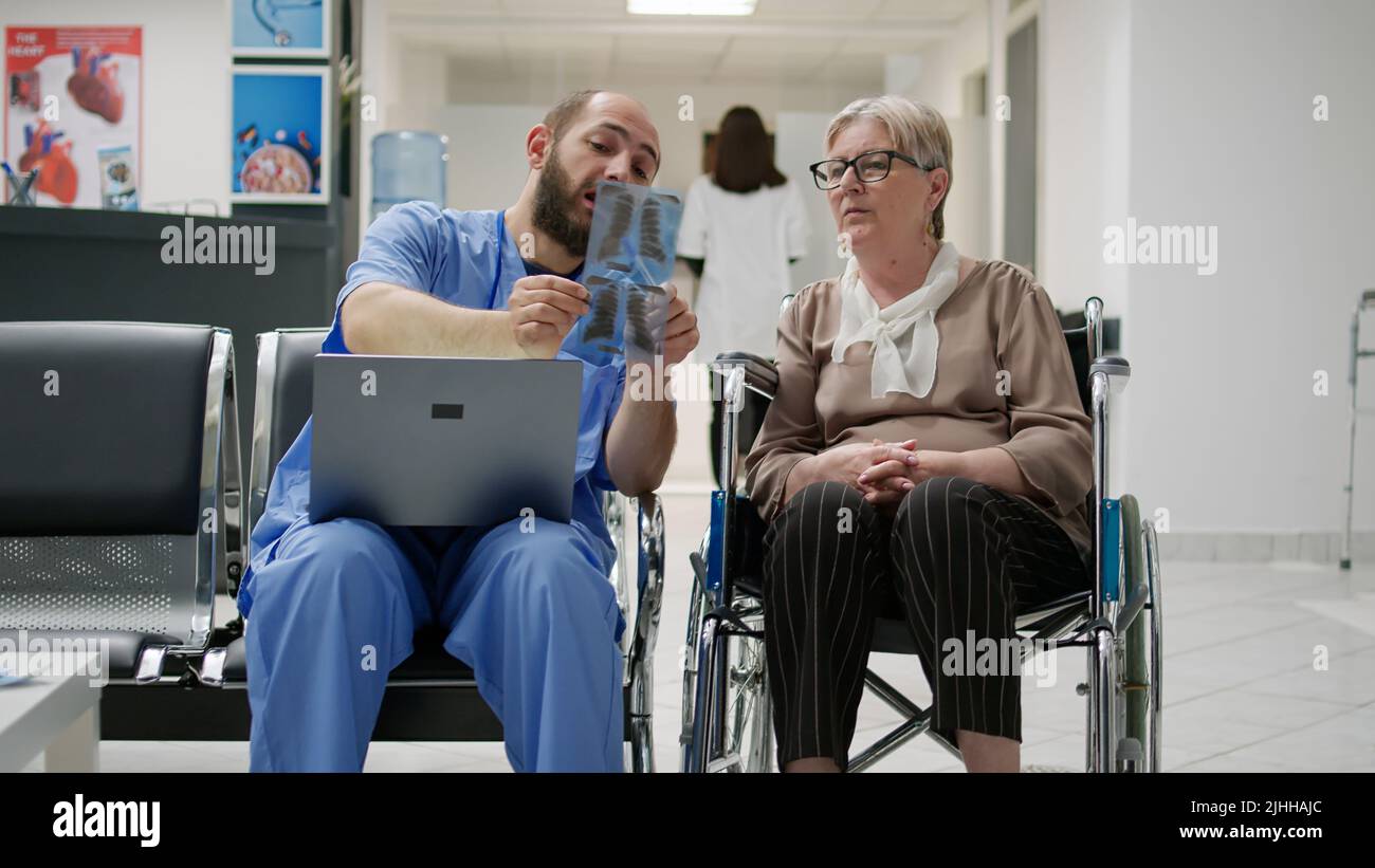 Patient with chronic disability looking at x ray scan results to talk ...