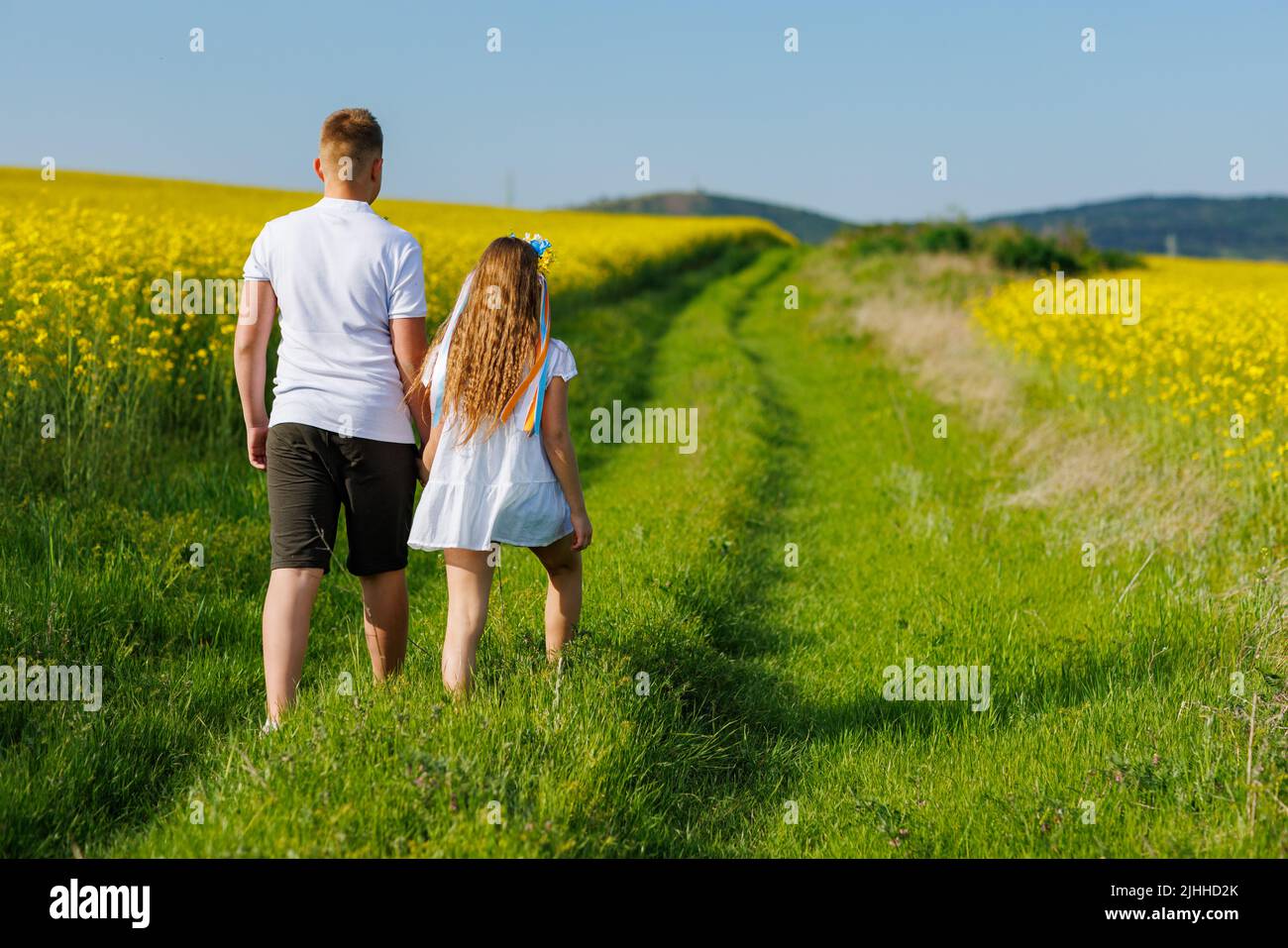 Rear view of happy carefree native children: older teenage brother and ...