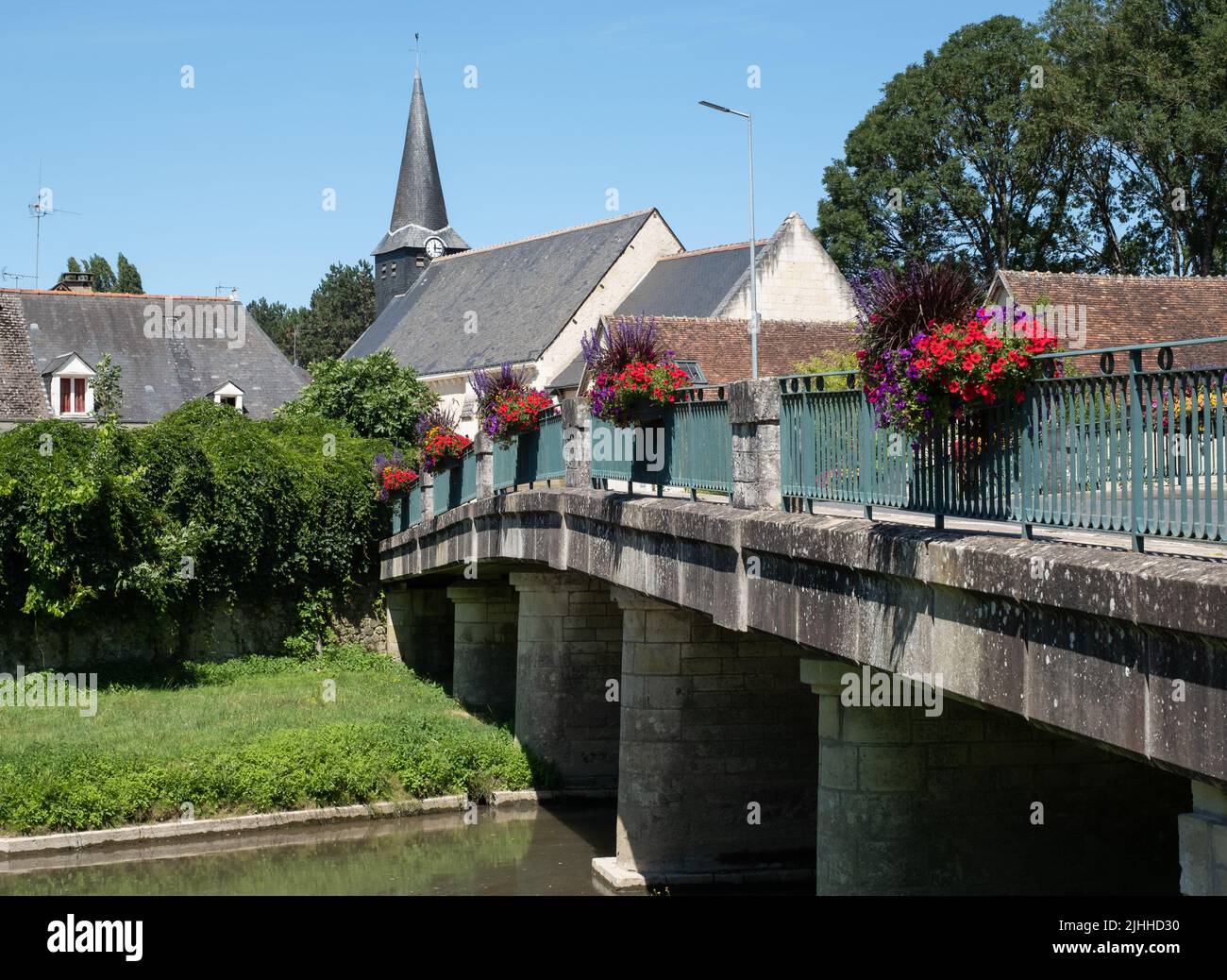 Bridge with flowers over the River Indrois in the picturesque village ...