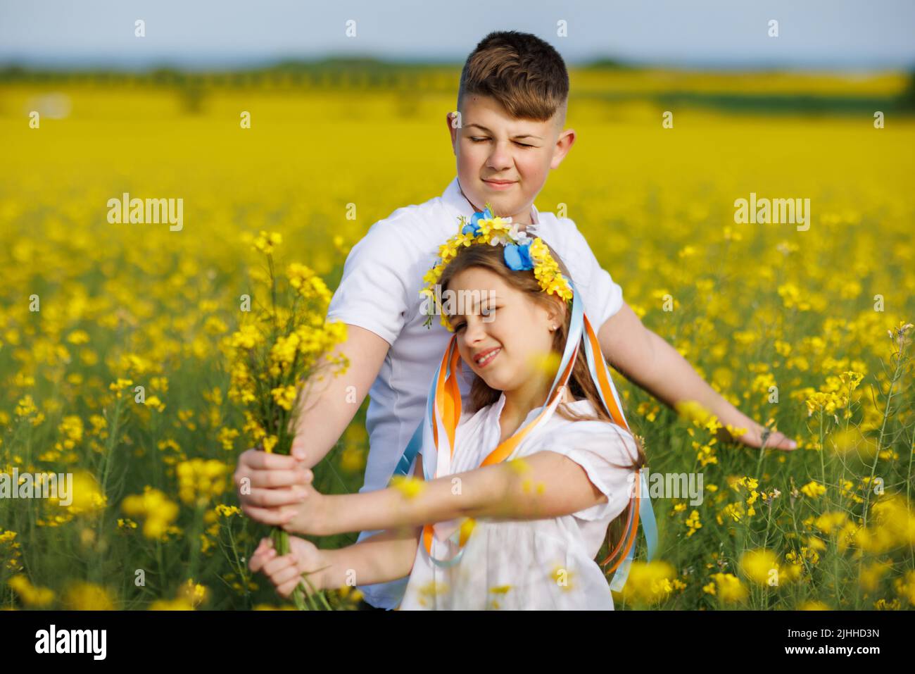 Front view of happy carefree native children: older teenage brother and ...