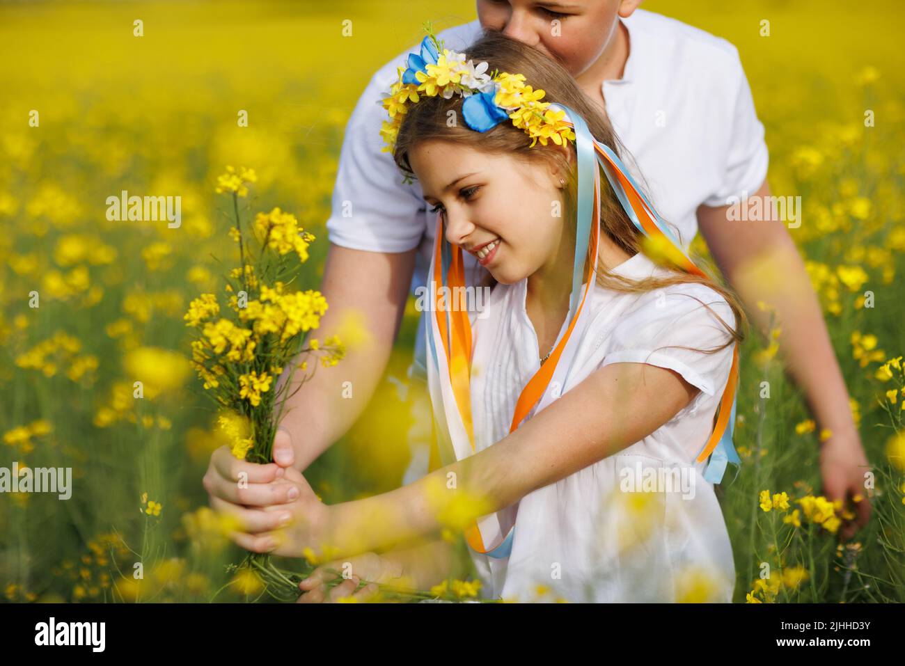 Front view of happy carefree native children: older teenage brother and ...
