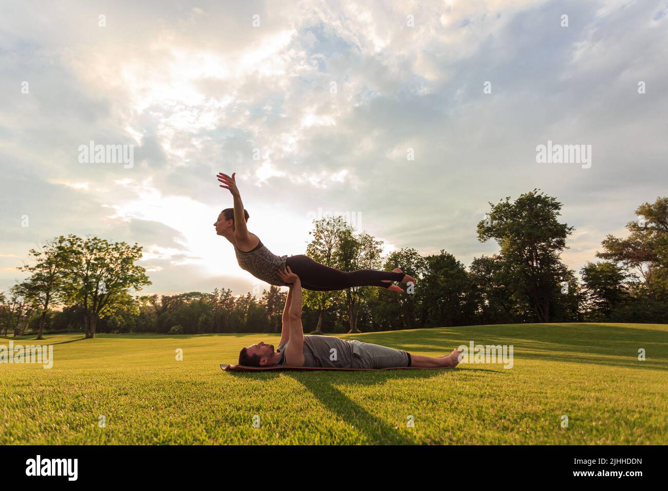 Strong acrobatic woman lifting man hi-res stock photography and images ...