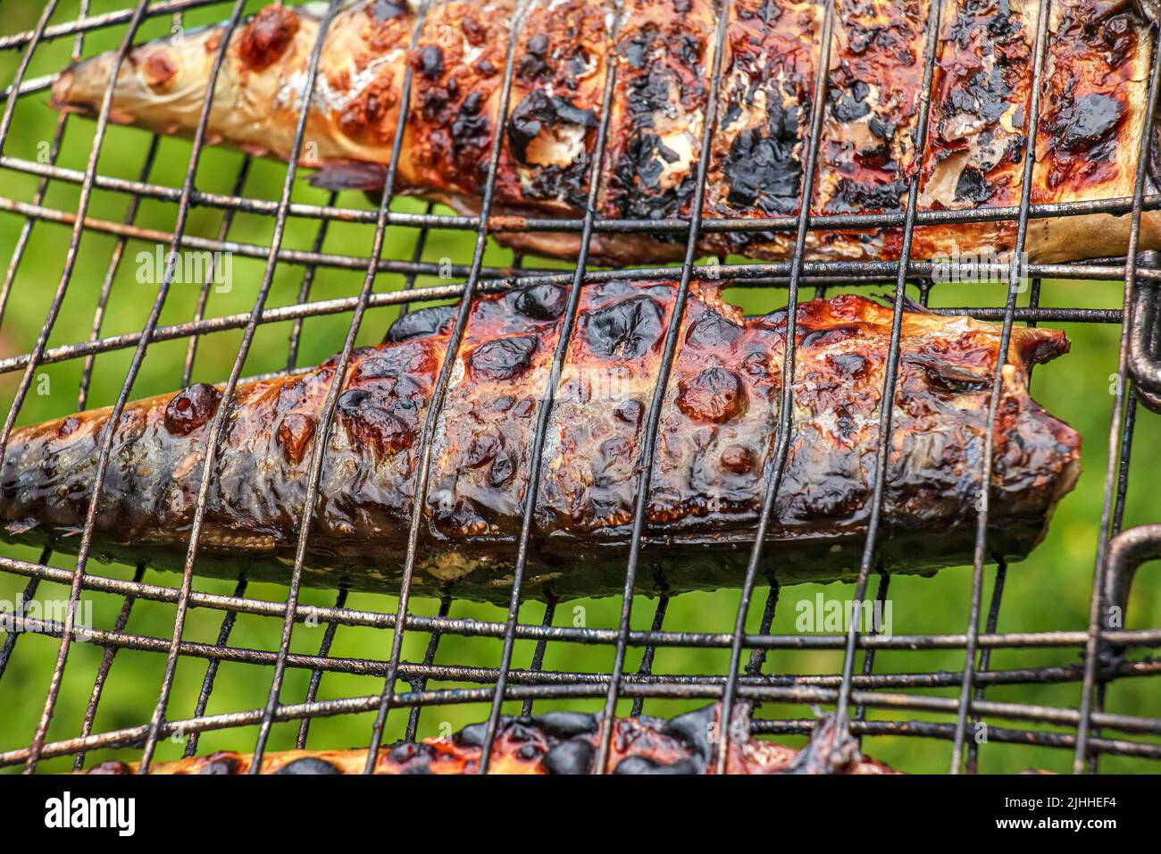 The process of cooking mackerel fish in a marinade on the grill. Fried ...