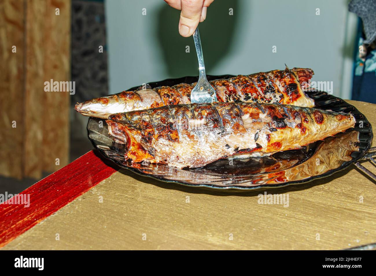 The process of cooking mackerel fish in a marinade on the grill. Fried ...
