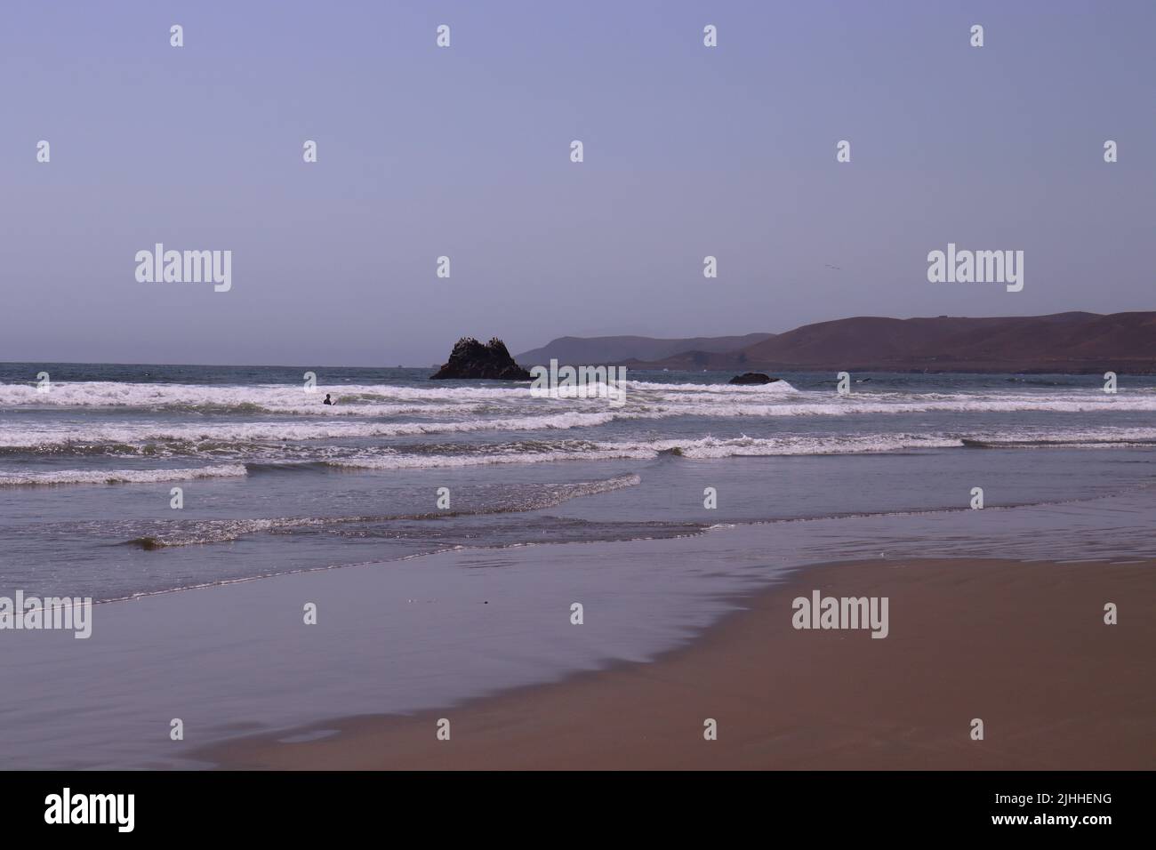 A calm, slightly overcast afternoon on a beach near Cayucos, CA with ...