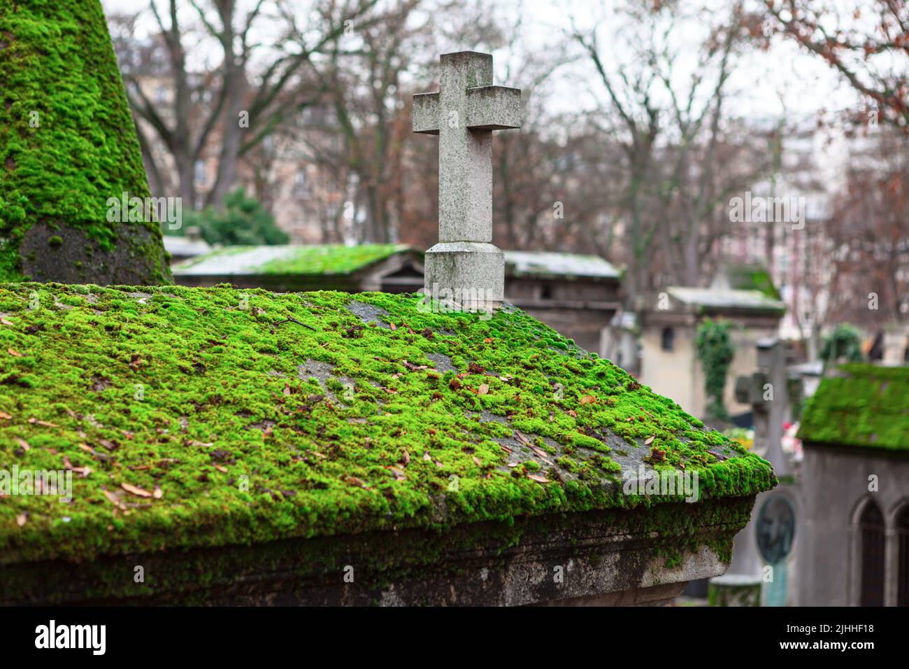 Tombstone covered with moss. Stone cross on the headstone Stock Photo ...