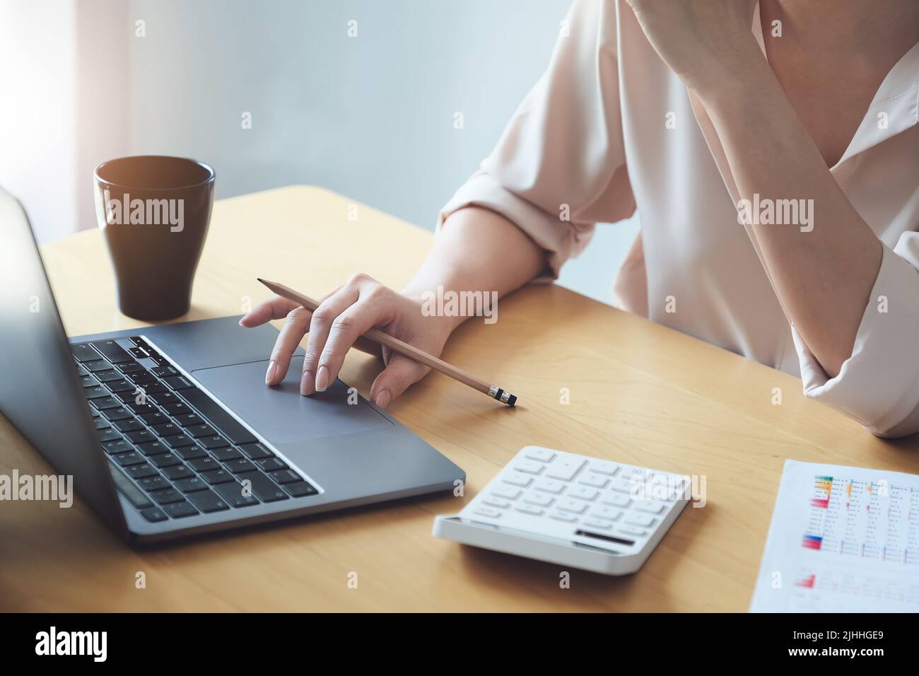 Business woman using computer to review balance sheet annual using ...