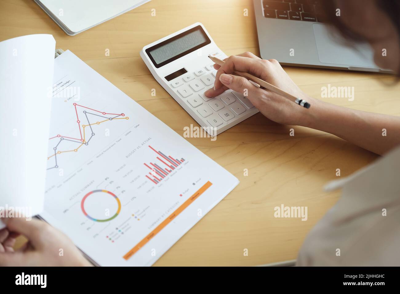 Business woman using calculator to review balance sheet annual using ...