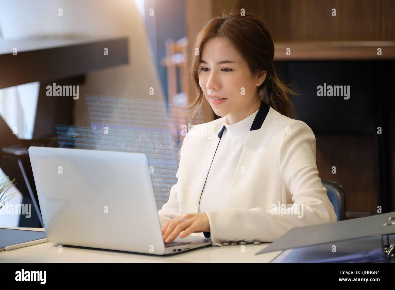 Business woman using computer to trade charts to find buy and sell ...