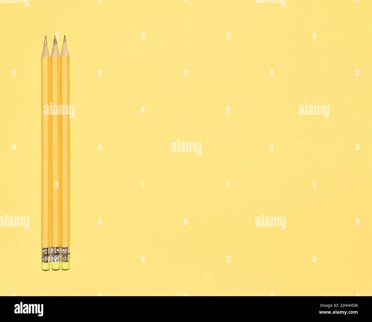 Wooden pastel yellow pencils with erasers on yellow background. Back to ...