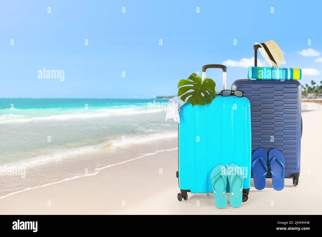 Packed suitcases with beach accessories on sea beach. Travel concept ...
