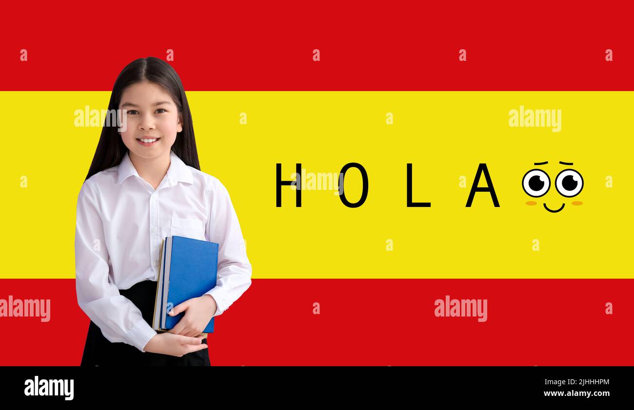 Little Asian schoolgirl and word HOLA (HELLO) against flag of Spain ...