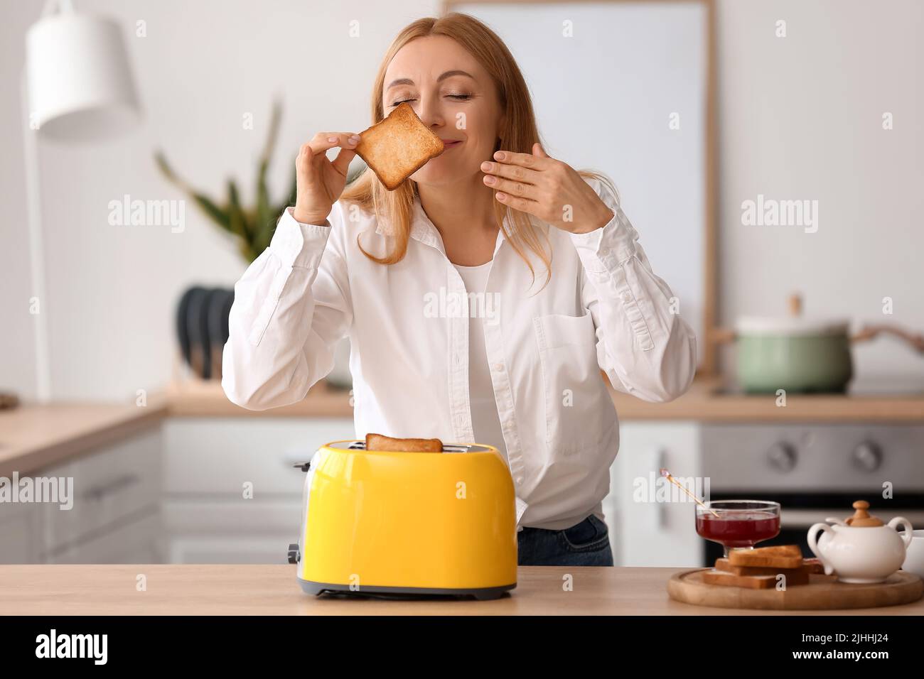 Mature woman in kitchen making jam hi-res stock photography and images ...