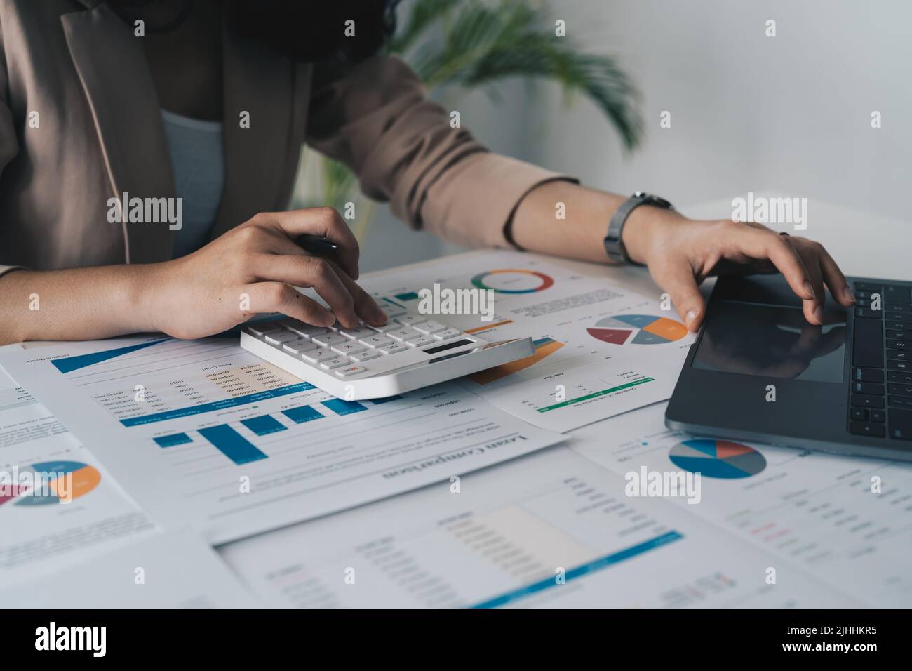 Woman accountant working with computer and calculator for business and ...