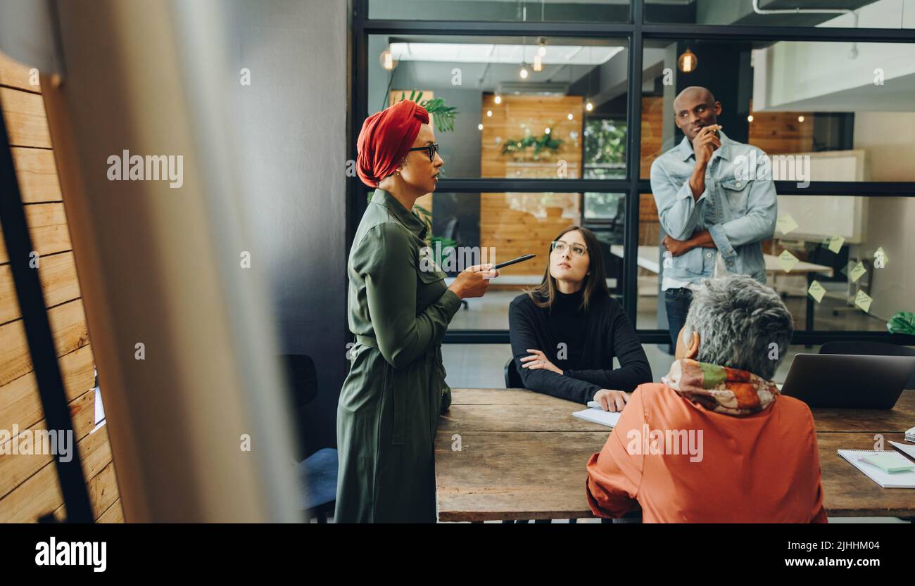 business manager giving a speech during an office meeting. Muslim ...