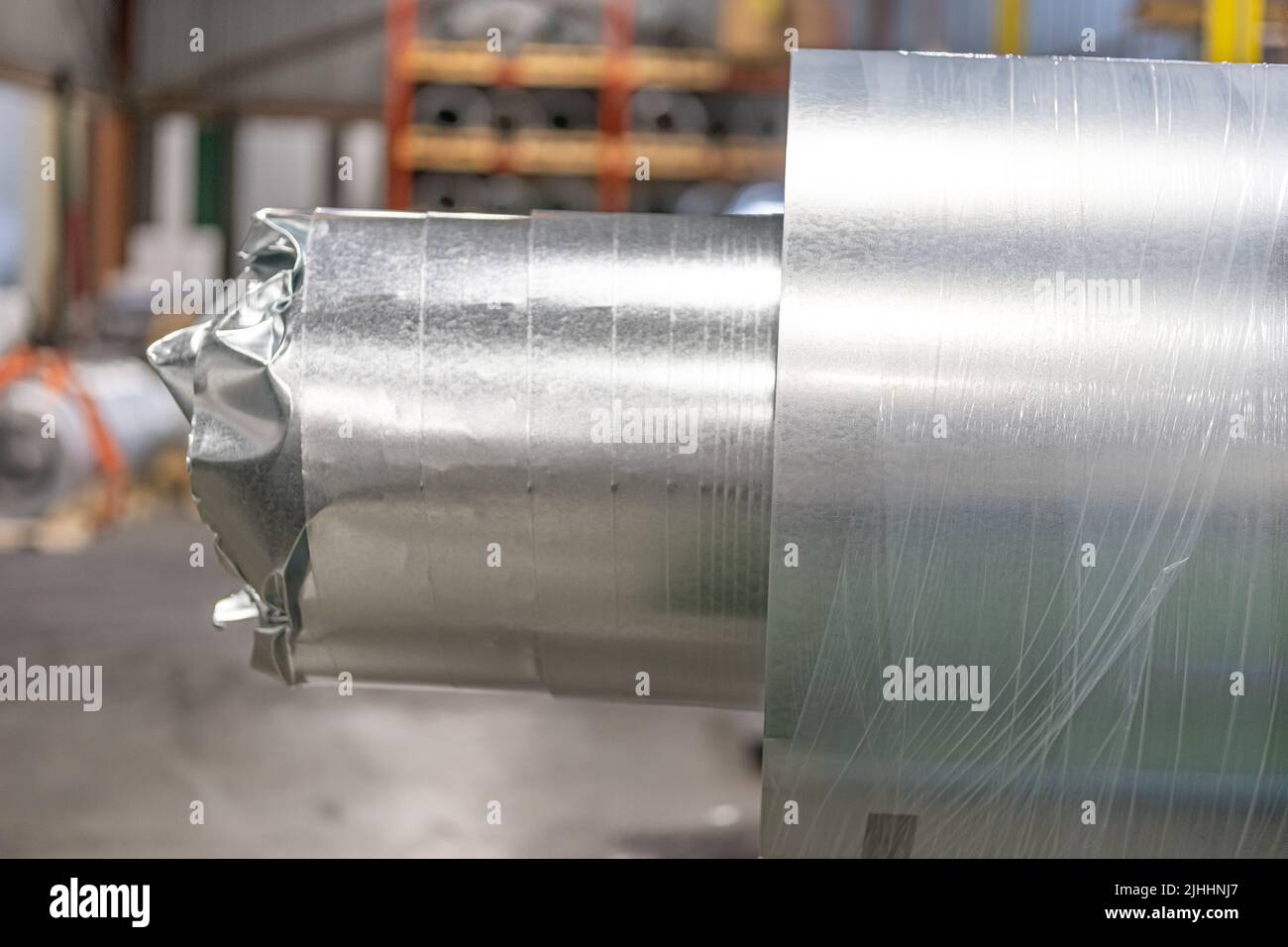 Damaged metal roll of coil on decoiling machine Stock Photo - Alamy