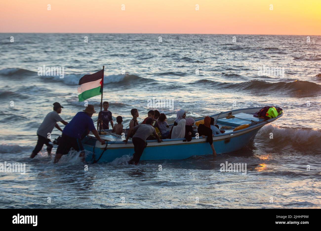 Palestinians spend their time on the shores of the Mediterranean Sea ...