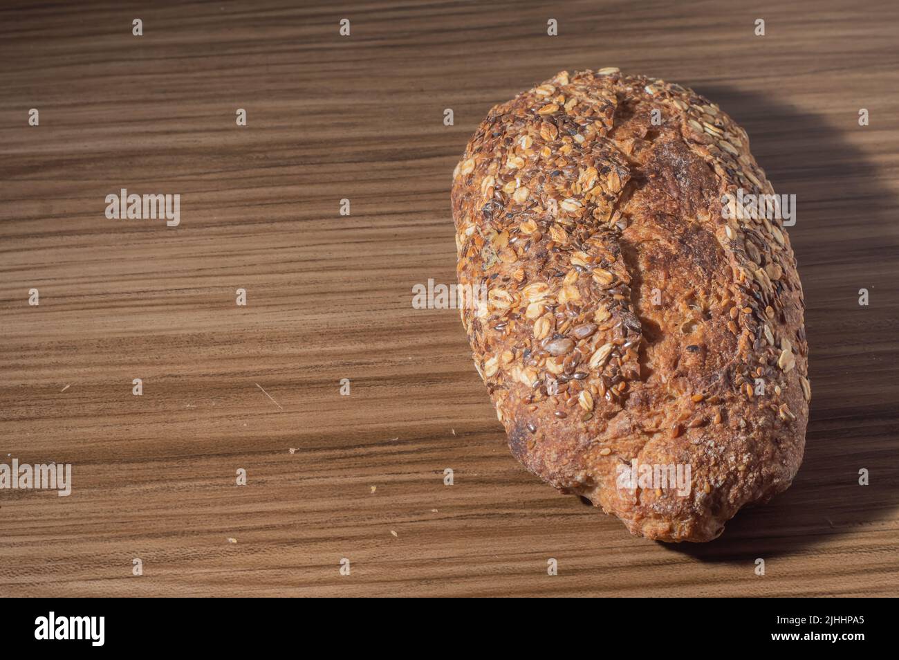 Whole wheat rye bread slice with seeds, multigrain bread on a wooden ...