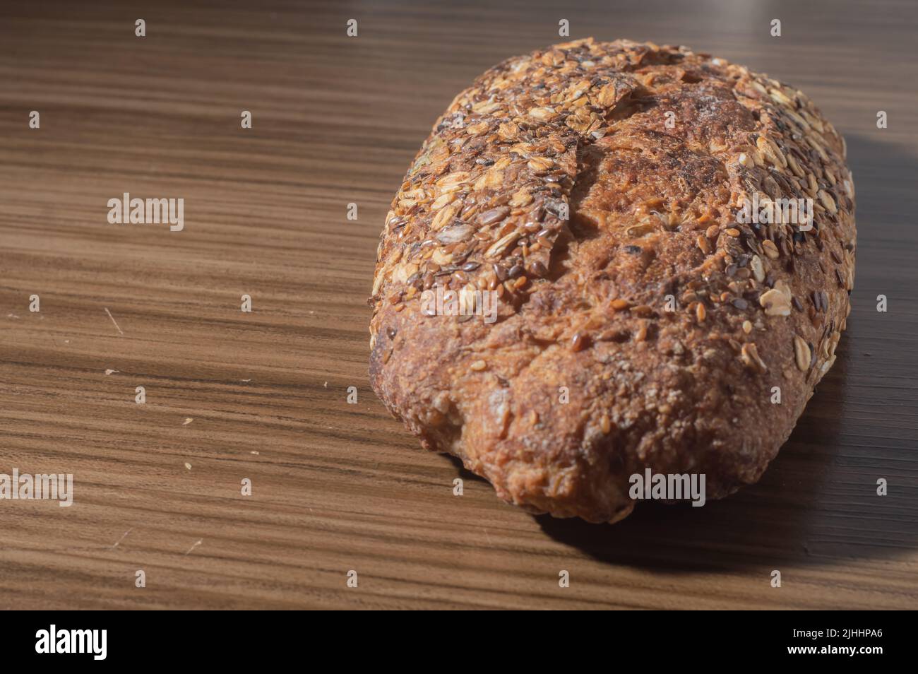 Whole wheat rye bread slice with seeds, multigrain bread on a wooden ...