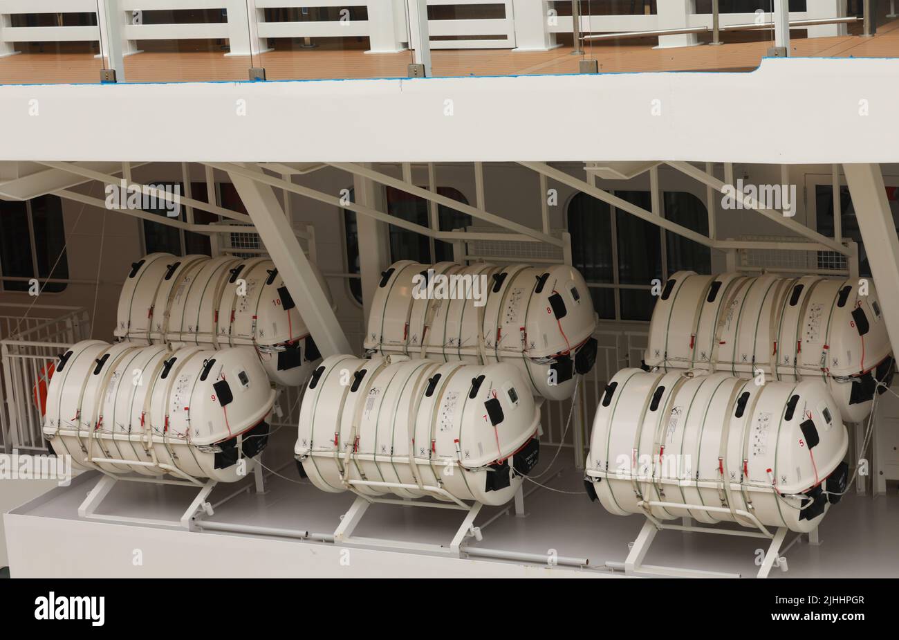 Life rafts on board a cruise ship Upwards capsules against a blue ...