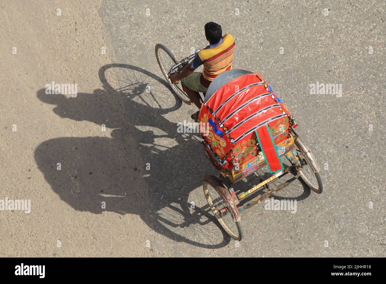 Dhaka, Bangladesh. 18th July, 2022. A rickshaw puller carries ...