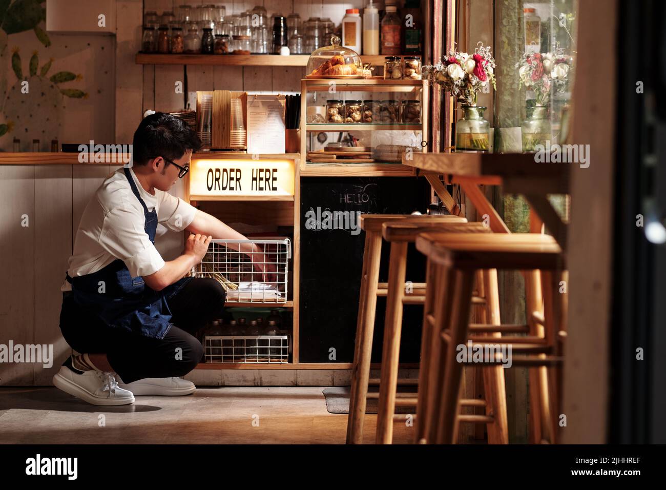 Coffeeshop barista taking note from order here box Stock Photo - Alamy