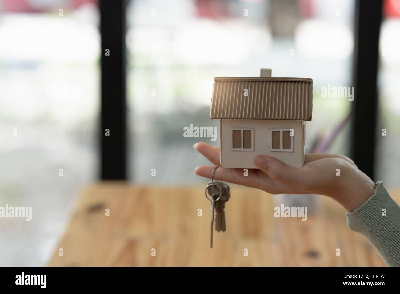 Close up Business woman or Real Estate agent giving house key after ...