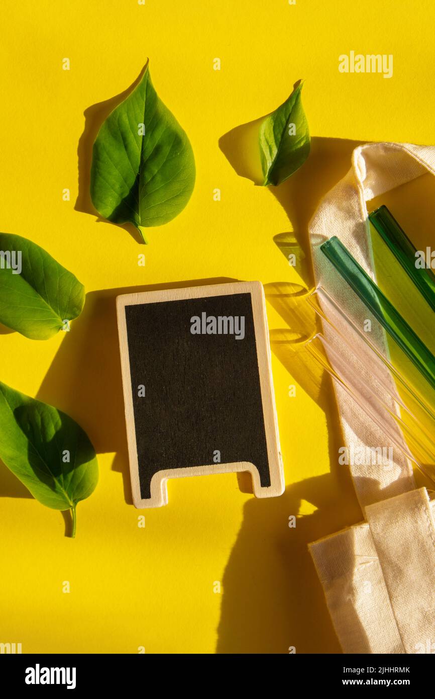 Reusable glass Straws on colorful background with green leafs in eco ...
