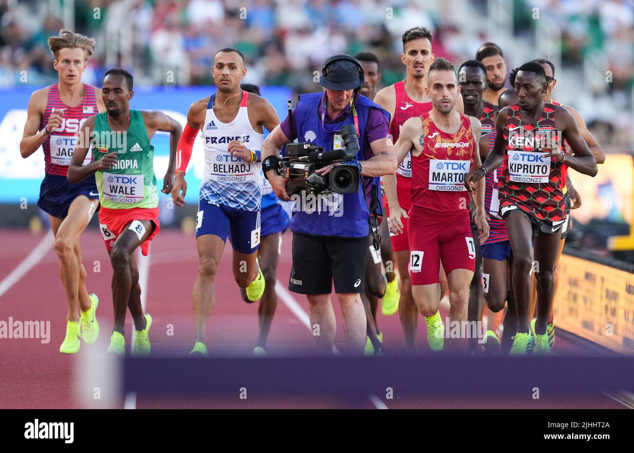 Runners during the Men’s 3000m Steeplechase run past a cameraman on day ...
