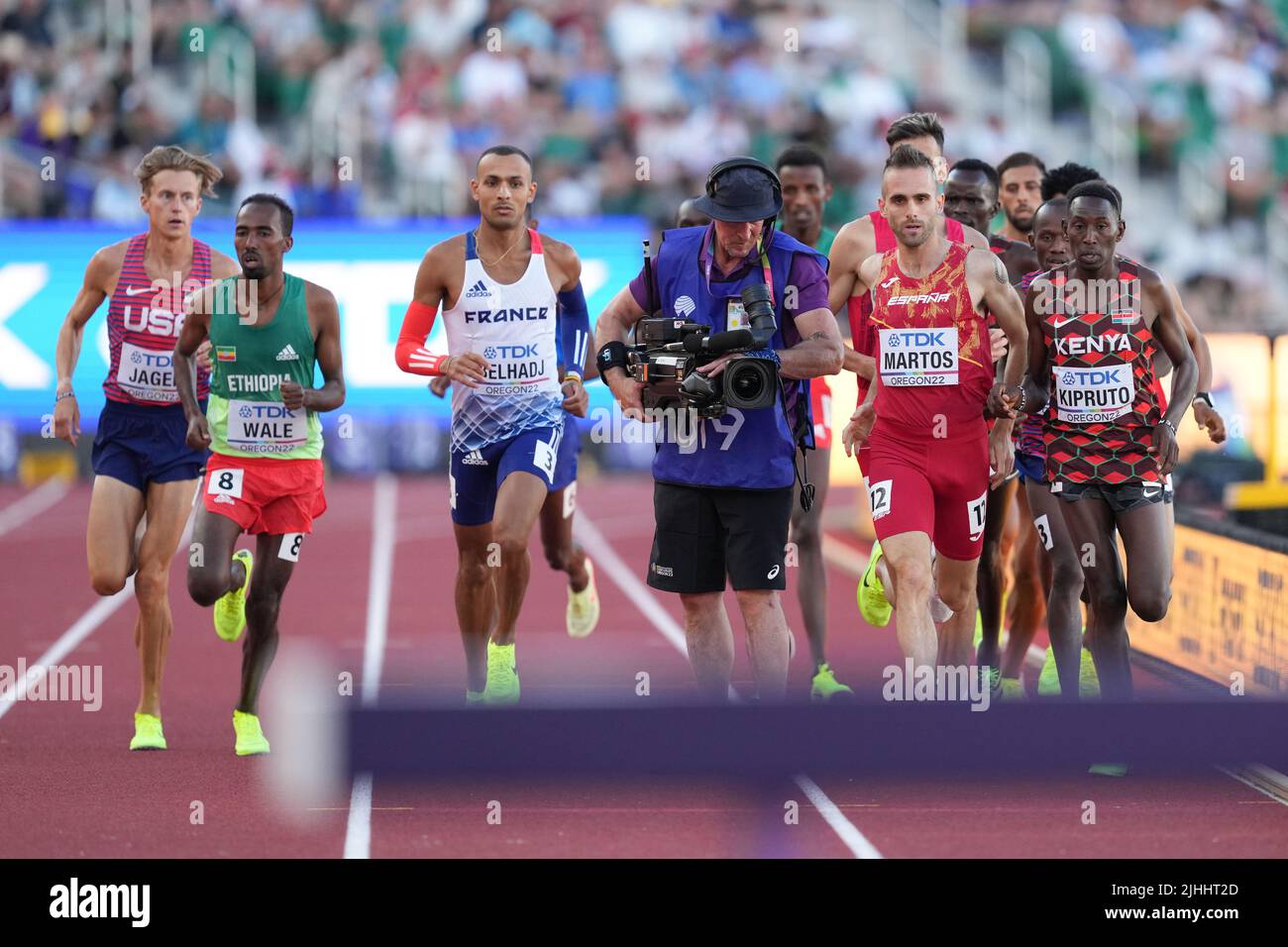 Runners during the Men’s 3000m Steeplechase run past a cameraman on day ...