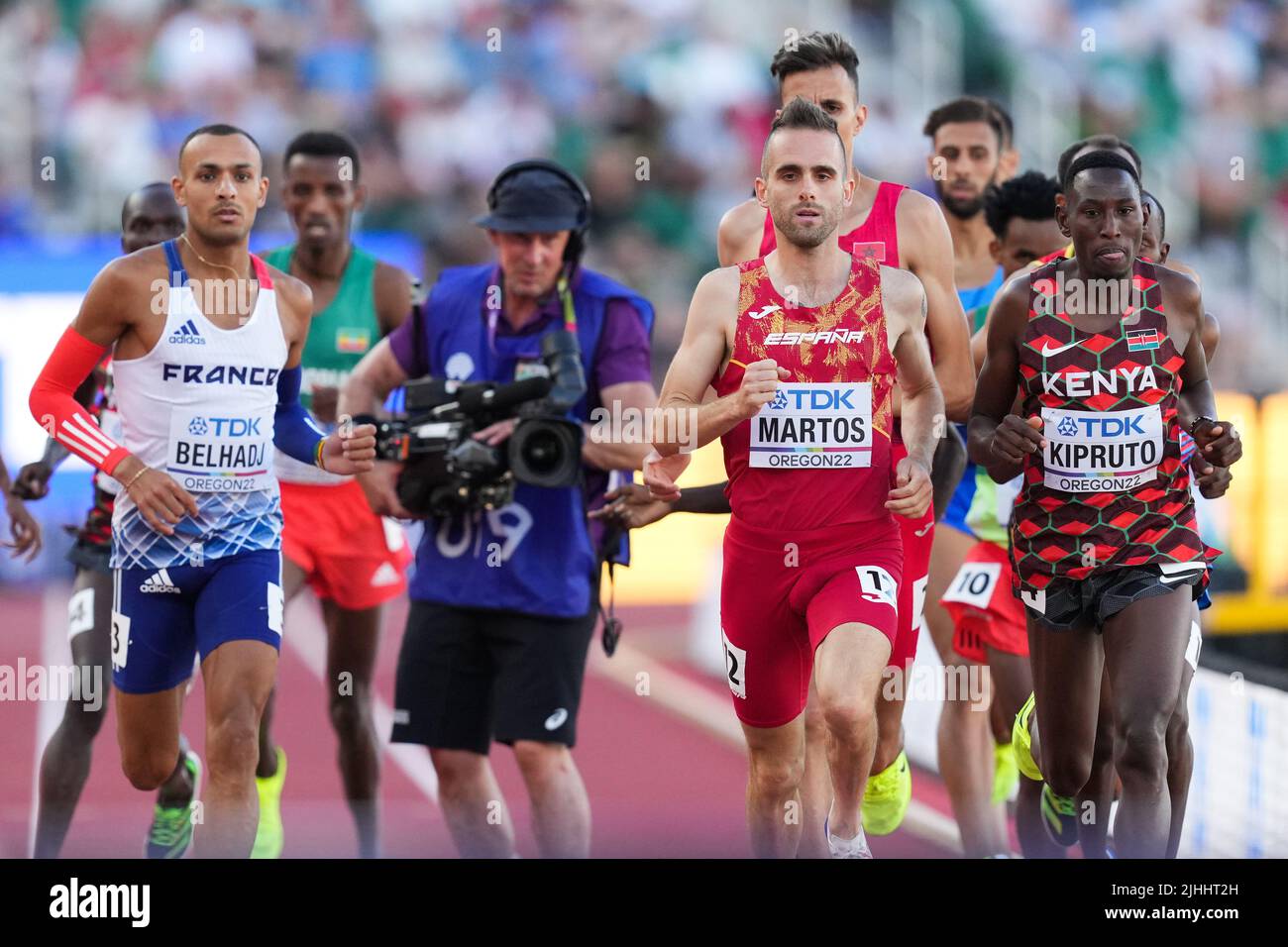 Runners during the Men’s 3000m Steeplechase run past a cameraman on day ...