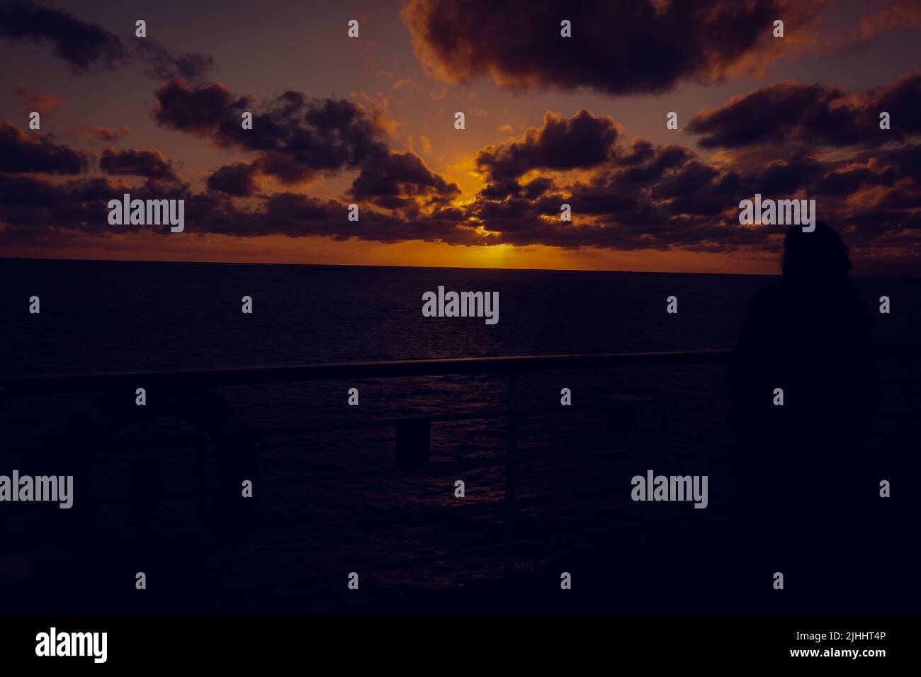 Wooden deck and railing from cruise ship. Beautiful sunset and ocean ...