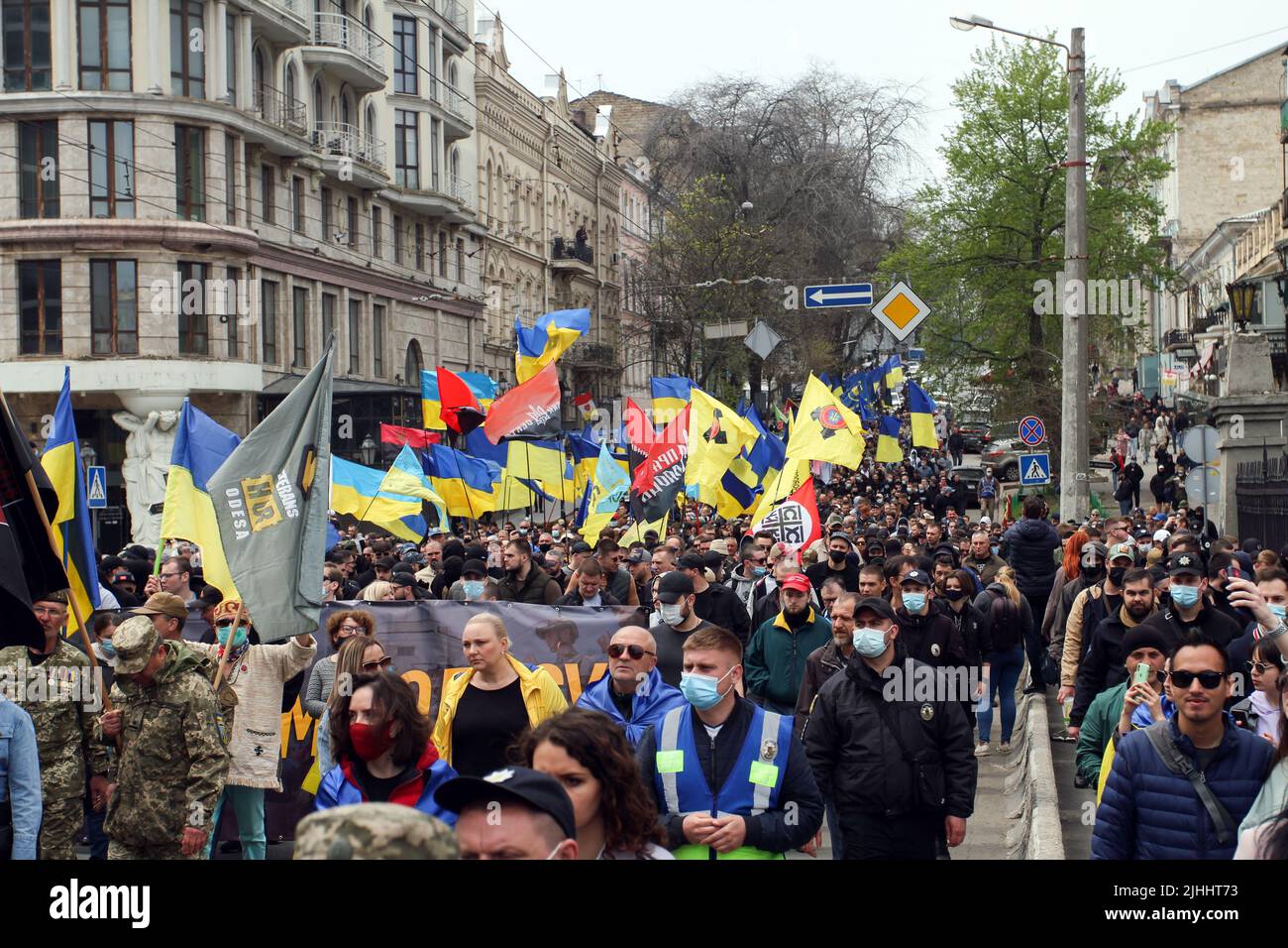 The marchers hold flags of Ukraine and the Ukrainian Insurgent Army ...