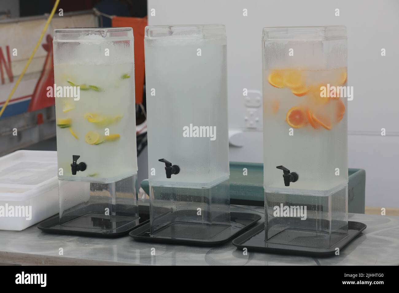 Refreshing transparent tanks with cold water and different flavors as ...