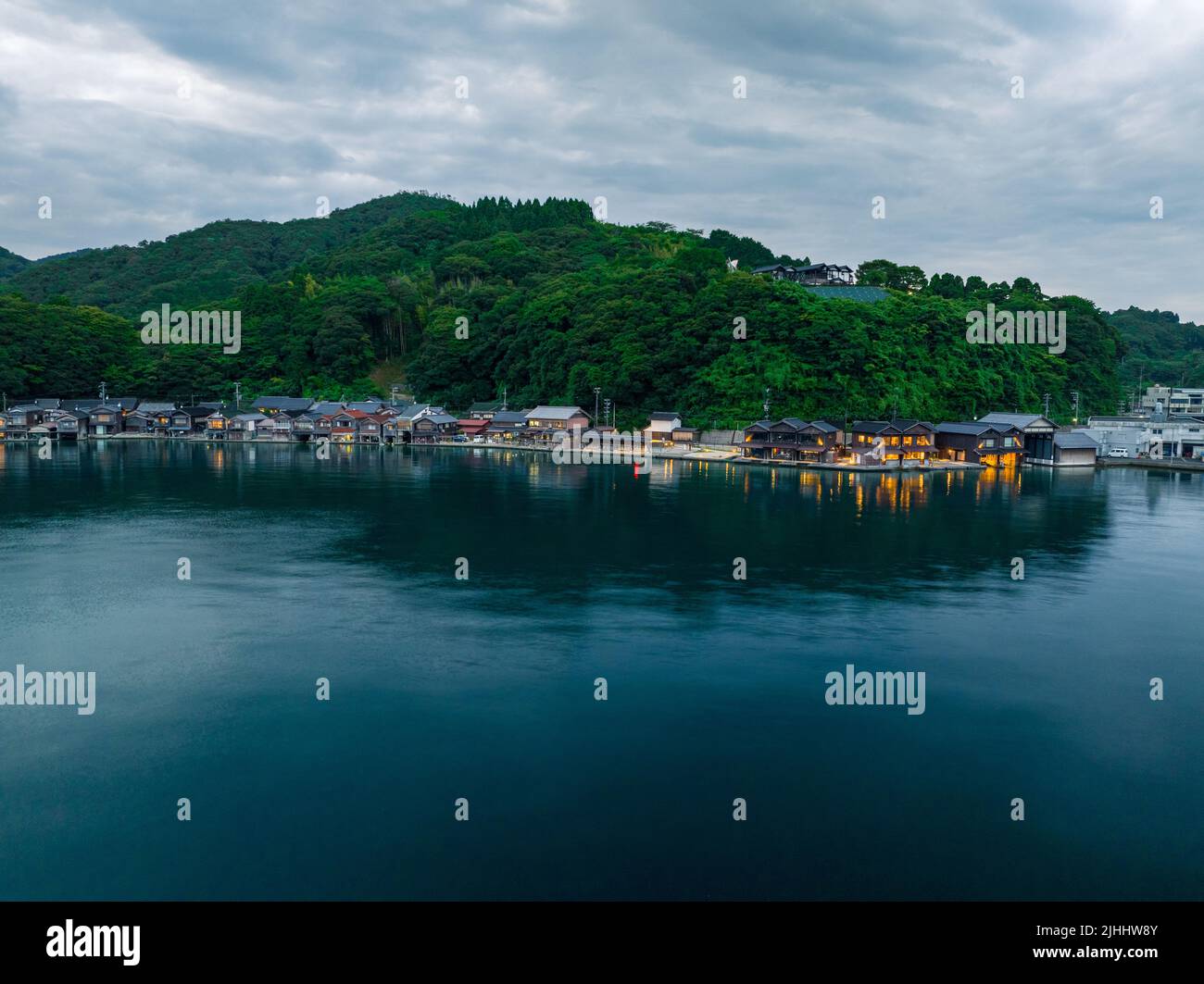 Traditional Japanese funaya boathouses lit at dusk in Ine fishing ...