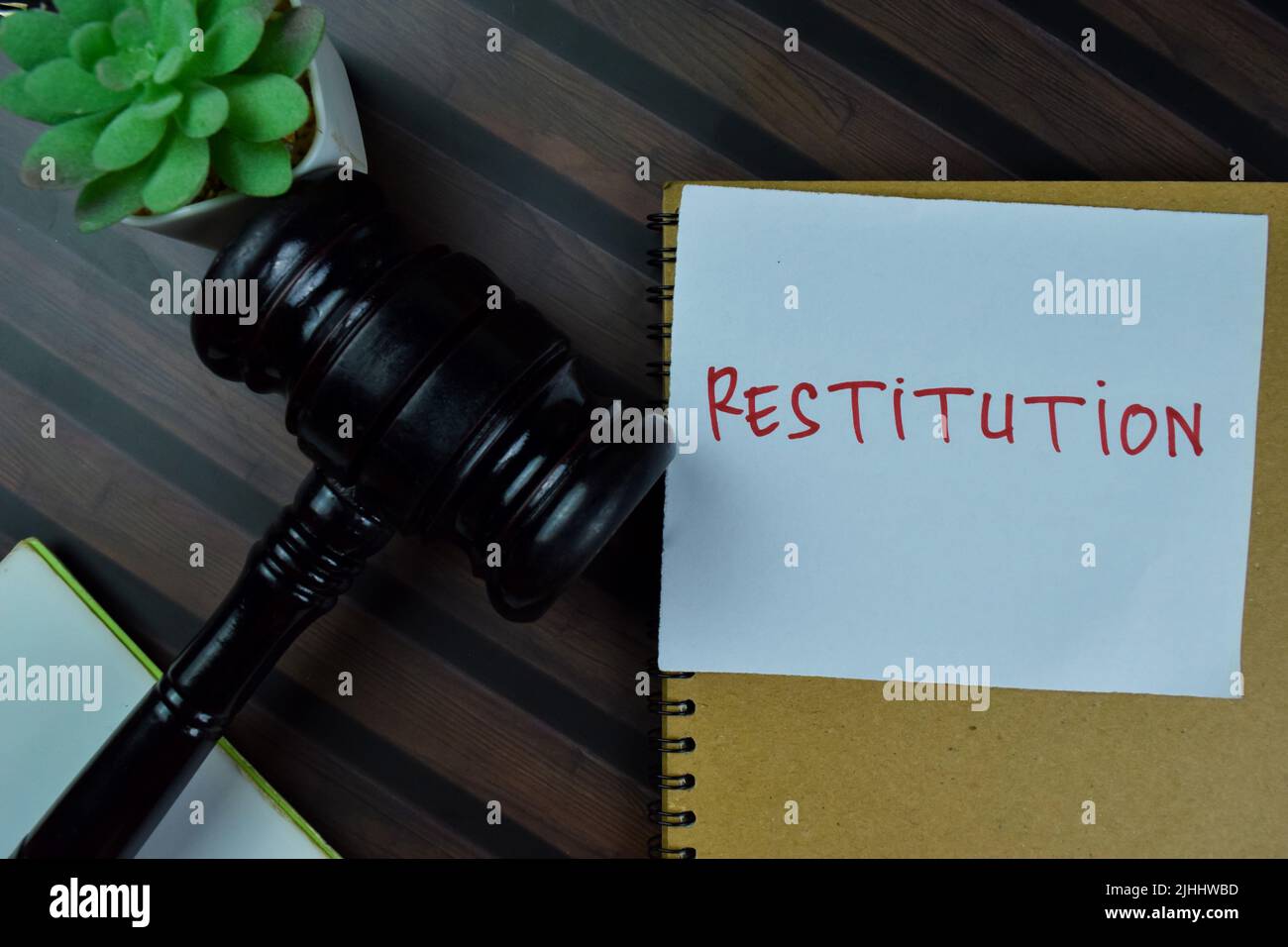 Concept of Restitution write on sticky notes with gavel isolated on ...