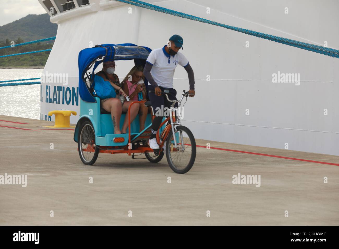 Bicycle rickshaw transferring guests from cruise ship terminal complex ...