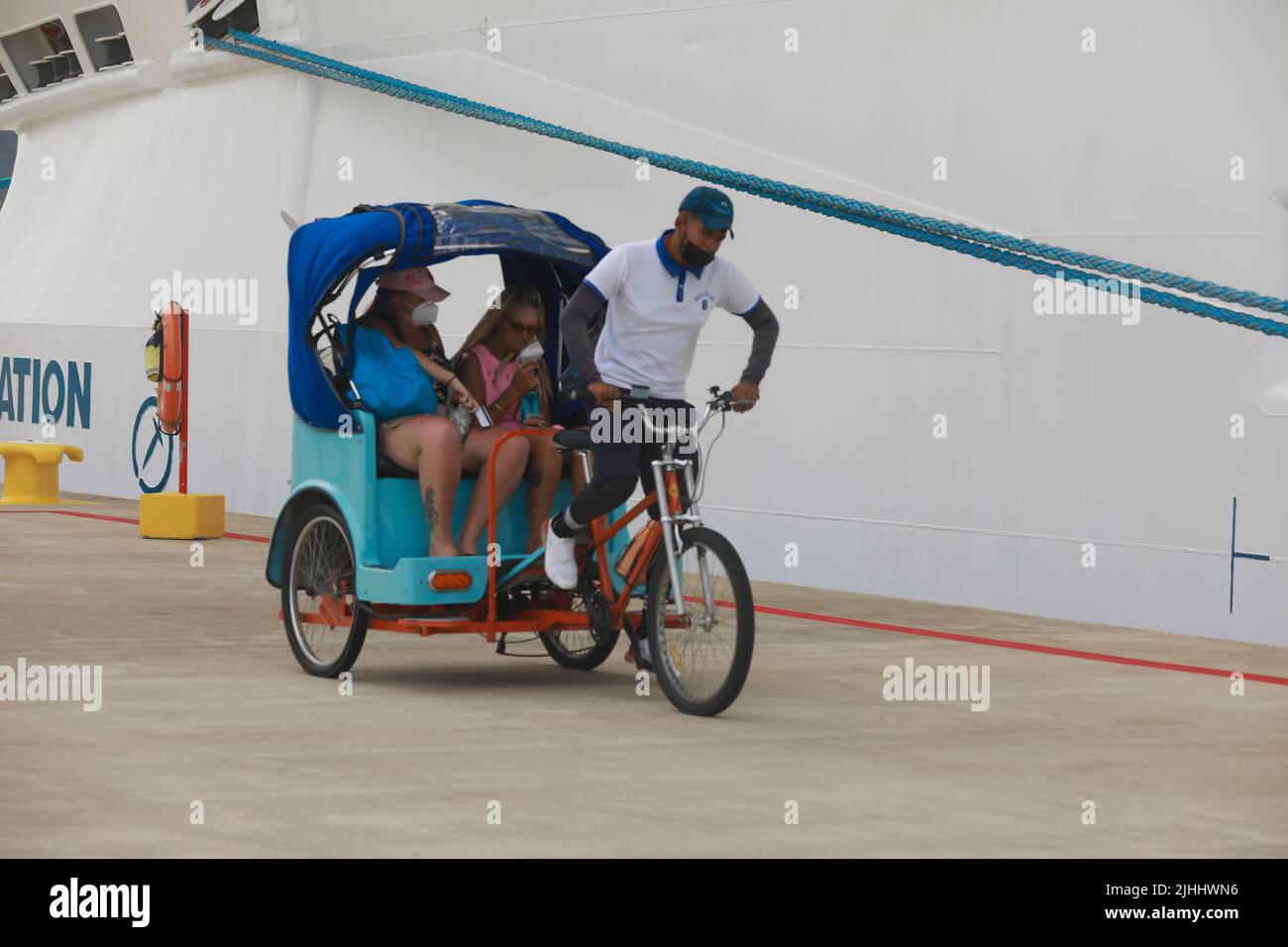 Bicycle rickshaw transferring guests from cruise ship terminal complex ...