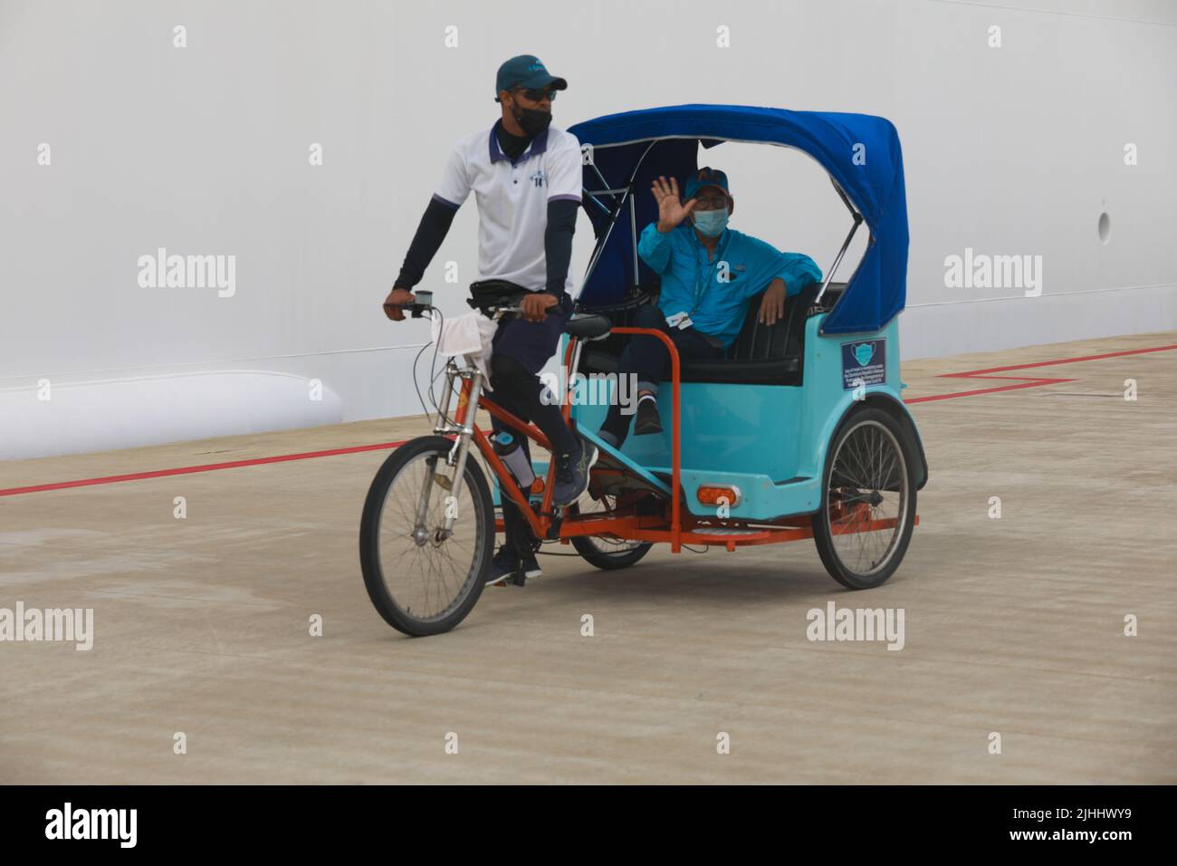 Bicycle rickshaw transferring guests from cruise ship terminal complex ...